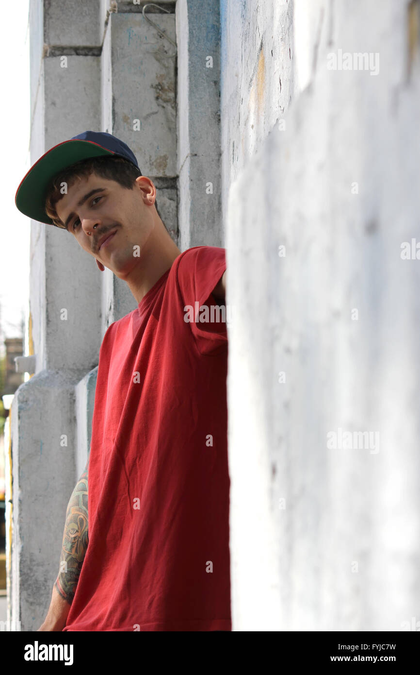 Rapper leaning on a Wall Stock Photo - Alamy