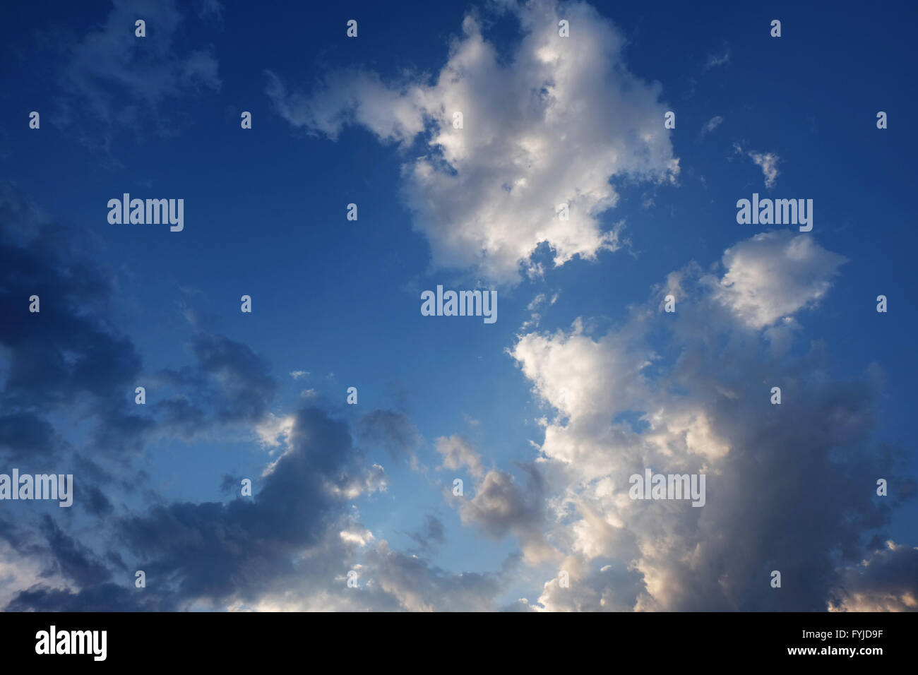 Light clouds in a blue evening sky at sunset Stock Photo - Alamy