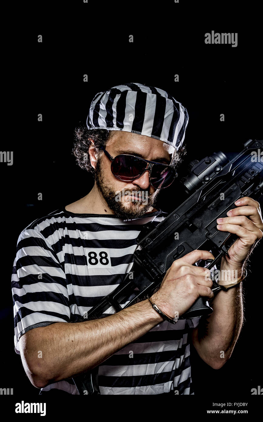 Weapon .Prison riot concept. Man holding a machine gun, prisoner Stock ...