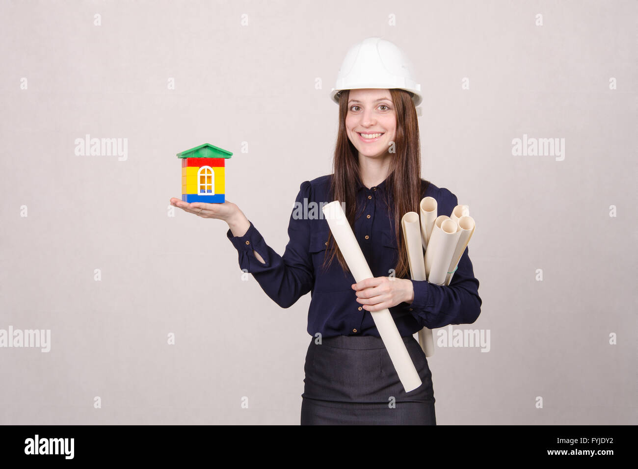 Woman architect with a house worth and drawing in hands Stock Photo - Alamy