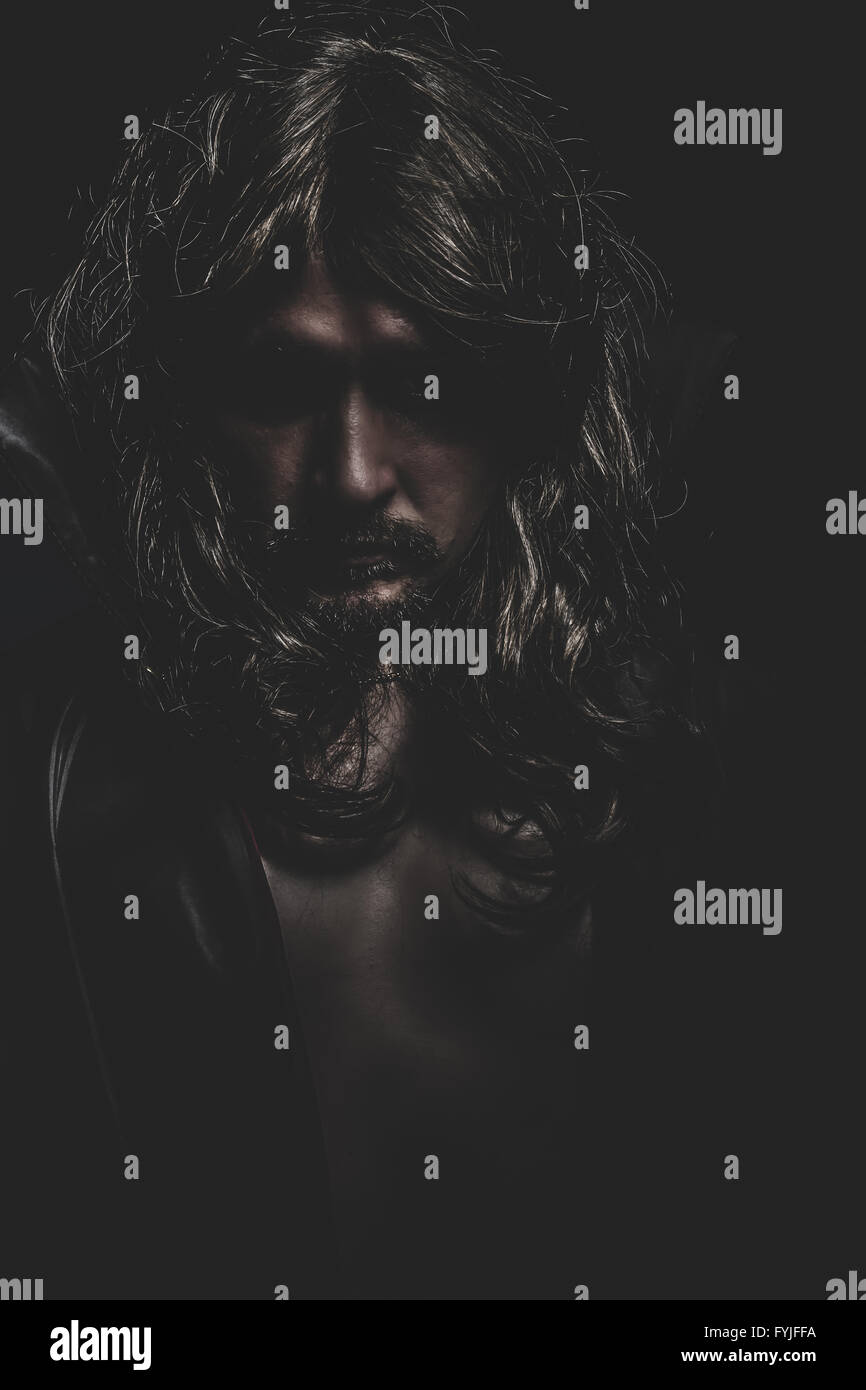 Vampire with black coat and long hair, sad Stock Photo - Alamy