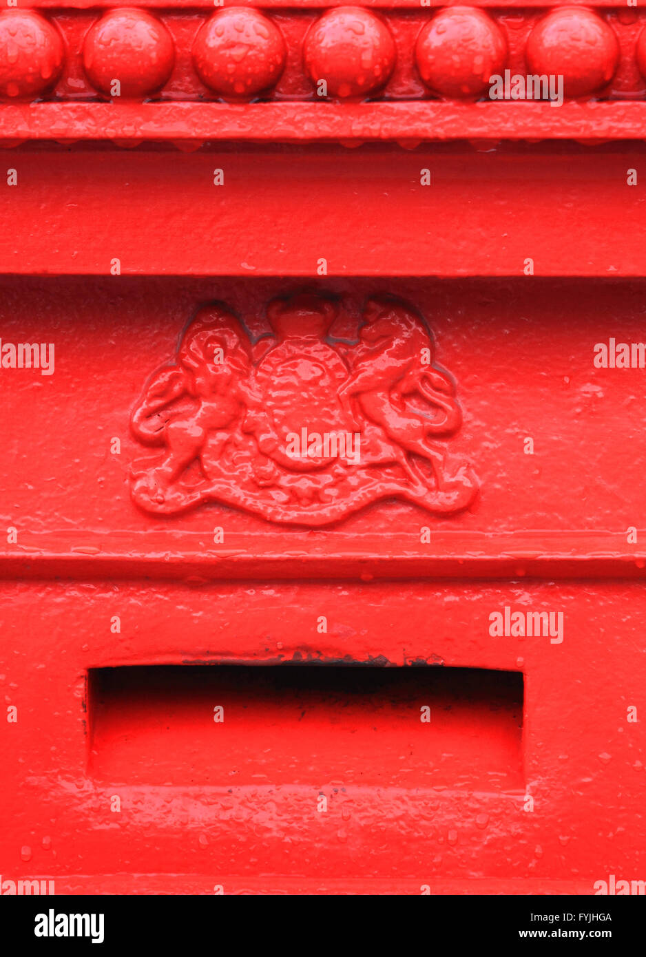 Old English red mailbox detail showing coat of arms and mail slot Stock ...