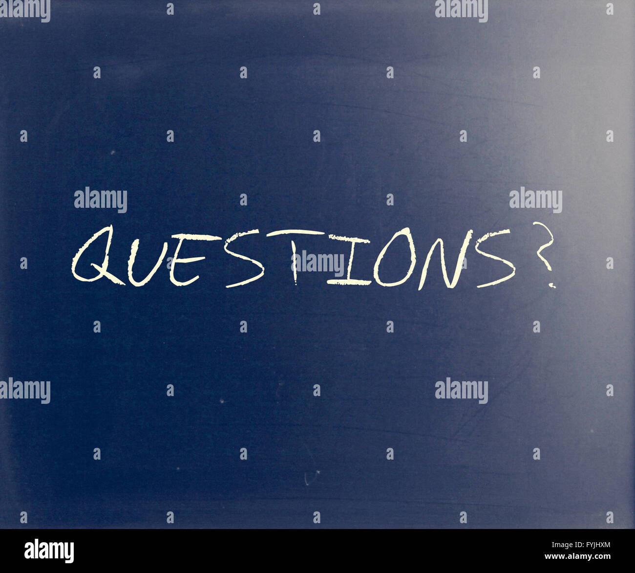 Questions? handwritten with white chalk on a blackboard Stock Photo - Alamy
