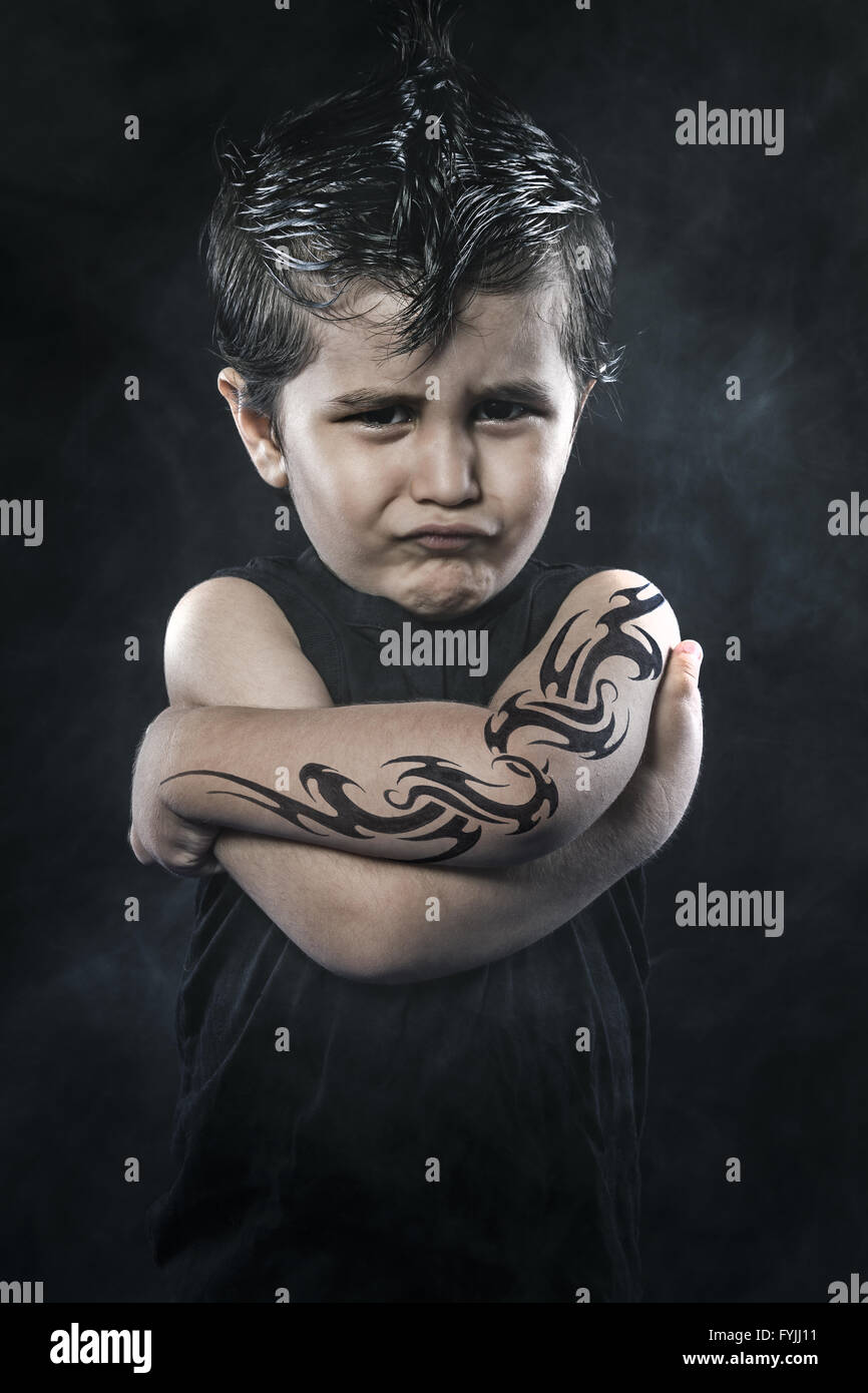Tattooed boy, rebellious child, funny guy with slicked back hair and ...