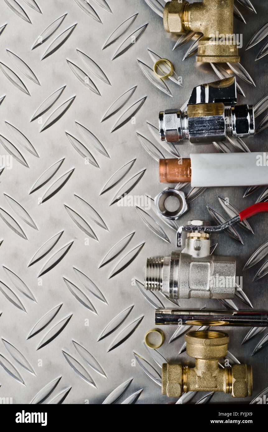 Plumbing inlet pipe valve on a metal surface Stock Photo - Alamy