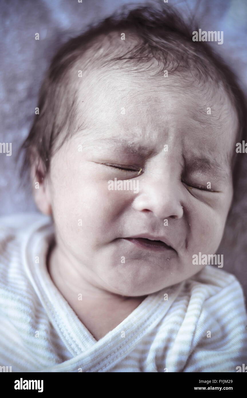 Adorable,new born baby curled up sleeping on a blanket, multiple ...