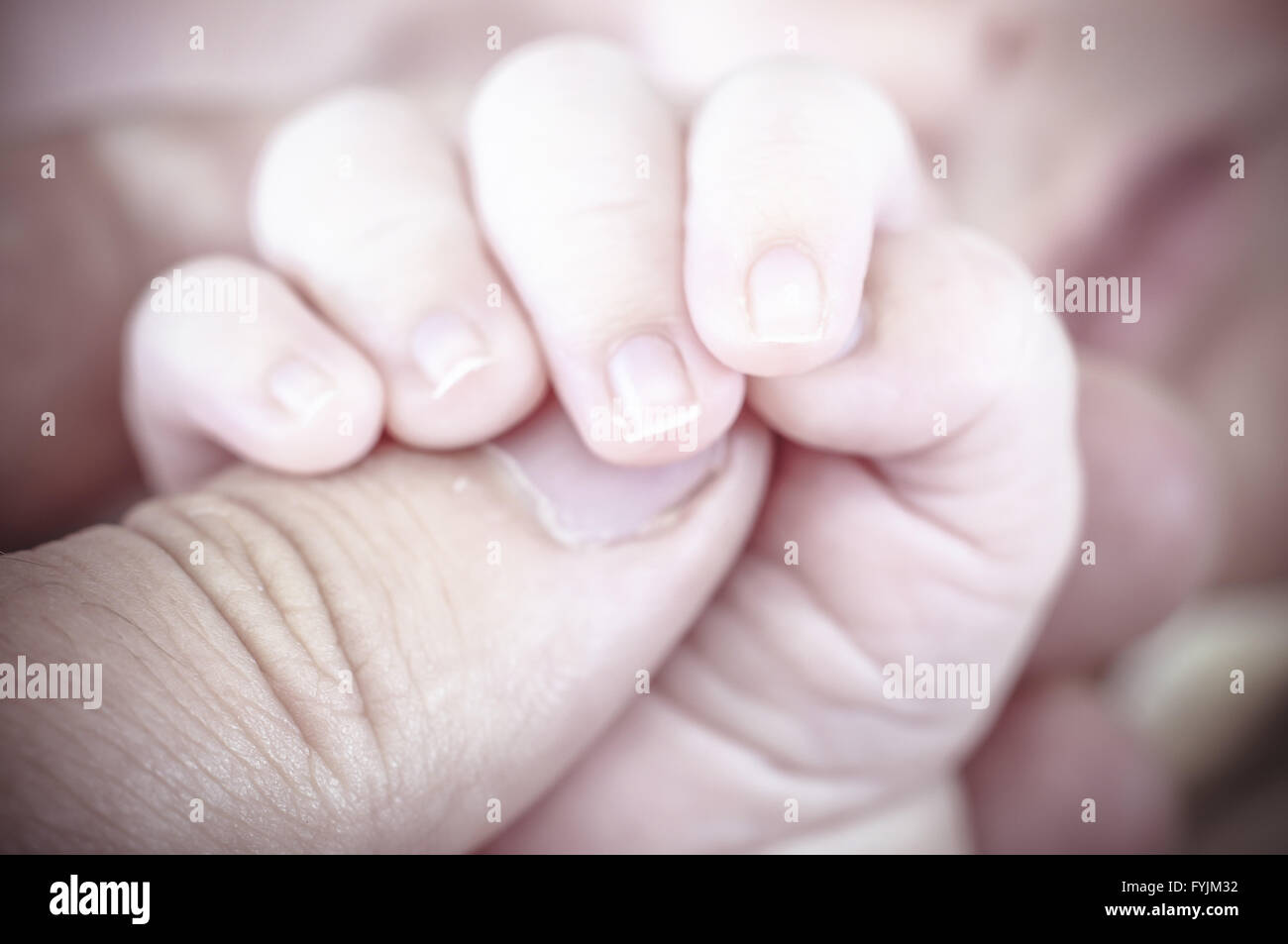 Hand, new born baby curled up sleeping on a blanket, multiple ...