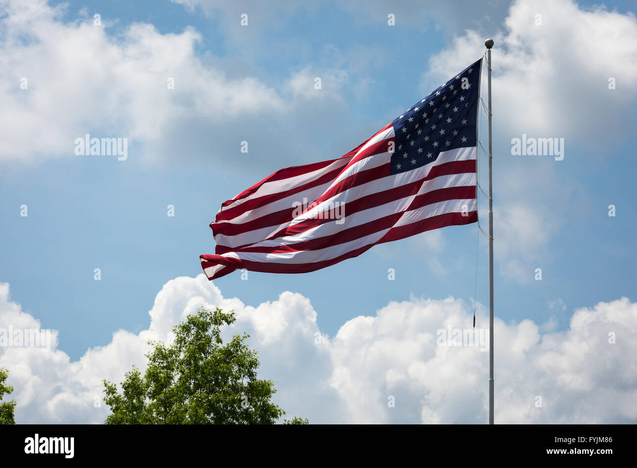 American Flag flying on a flag pole Stock Photo - Alamy