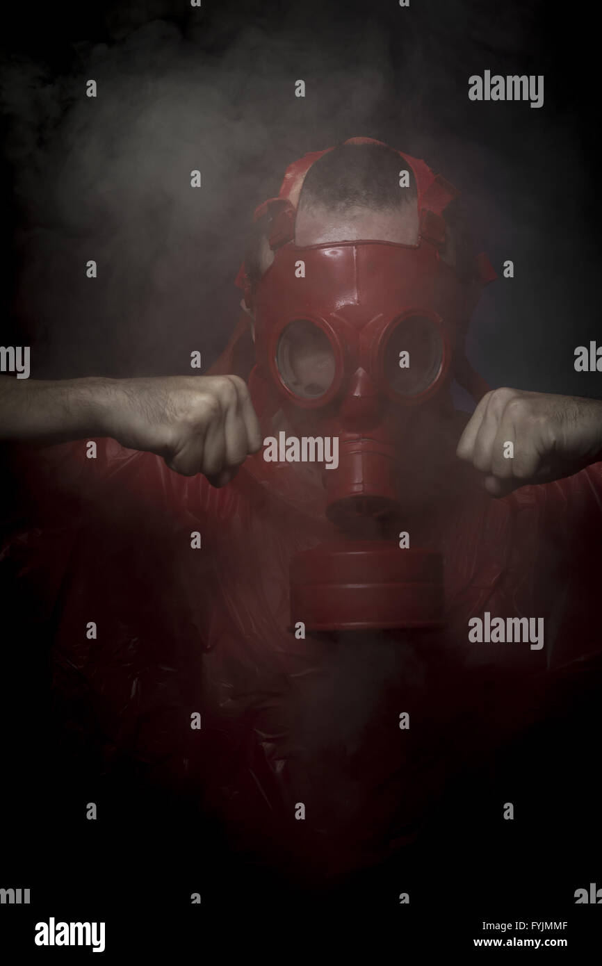 Radioactivity, A man in a gas mask over the smoke. black background and ...