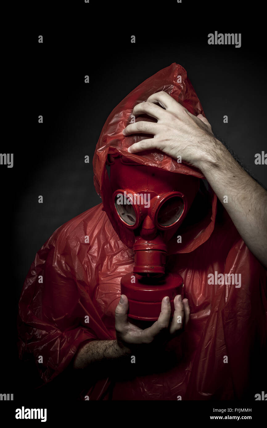 Toxic, A man in a gas mask over the smoke. black background and red ...