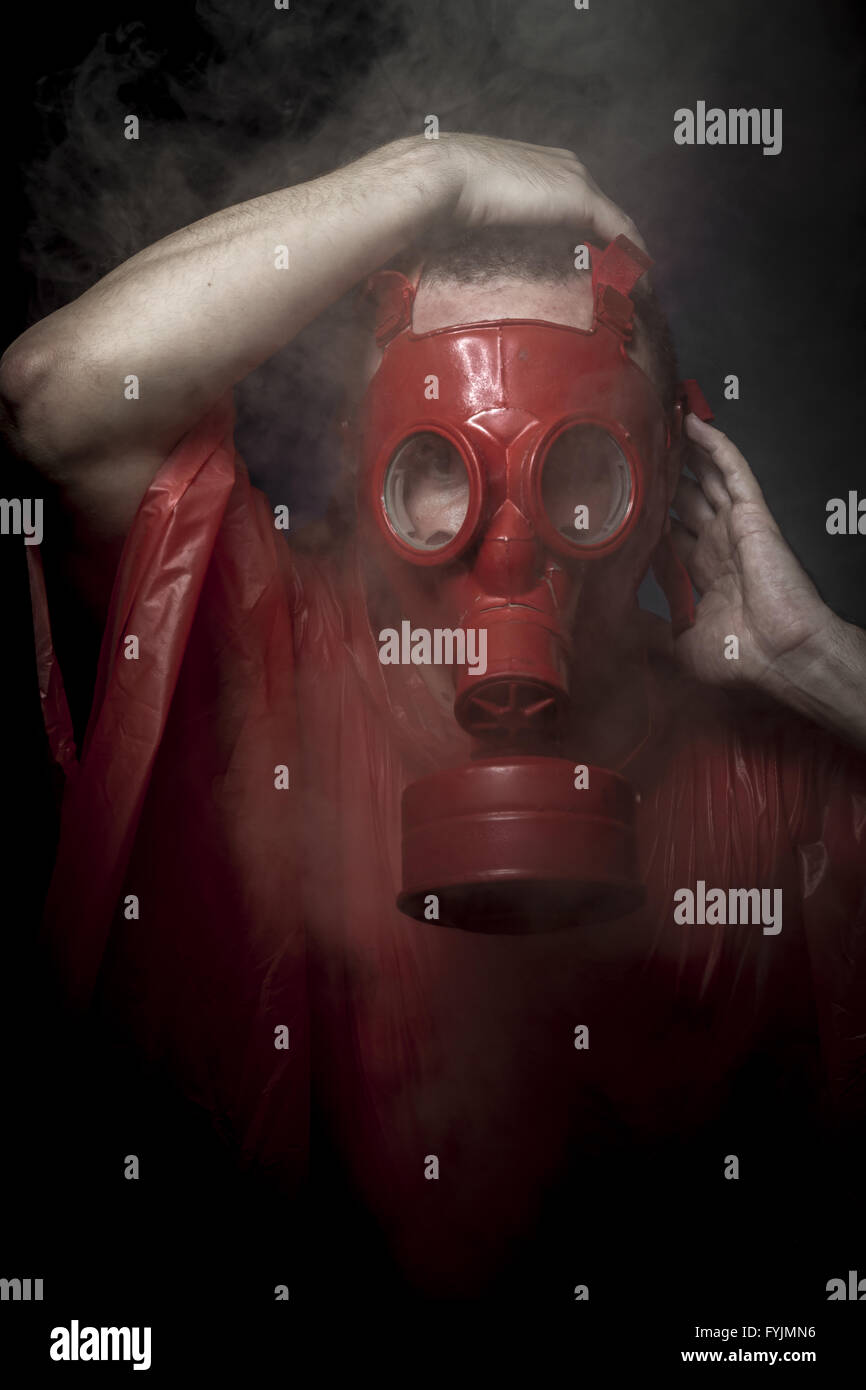 Cloak, A man in a gas mask over the smoke. black background and red ...