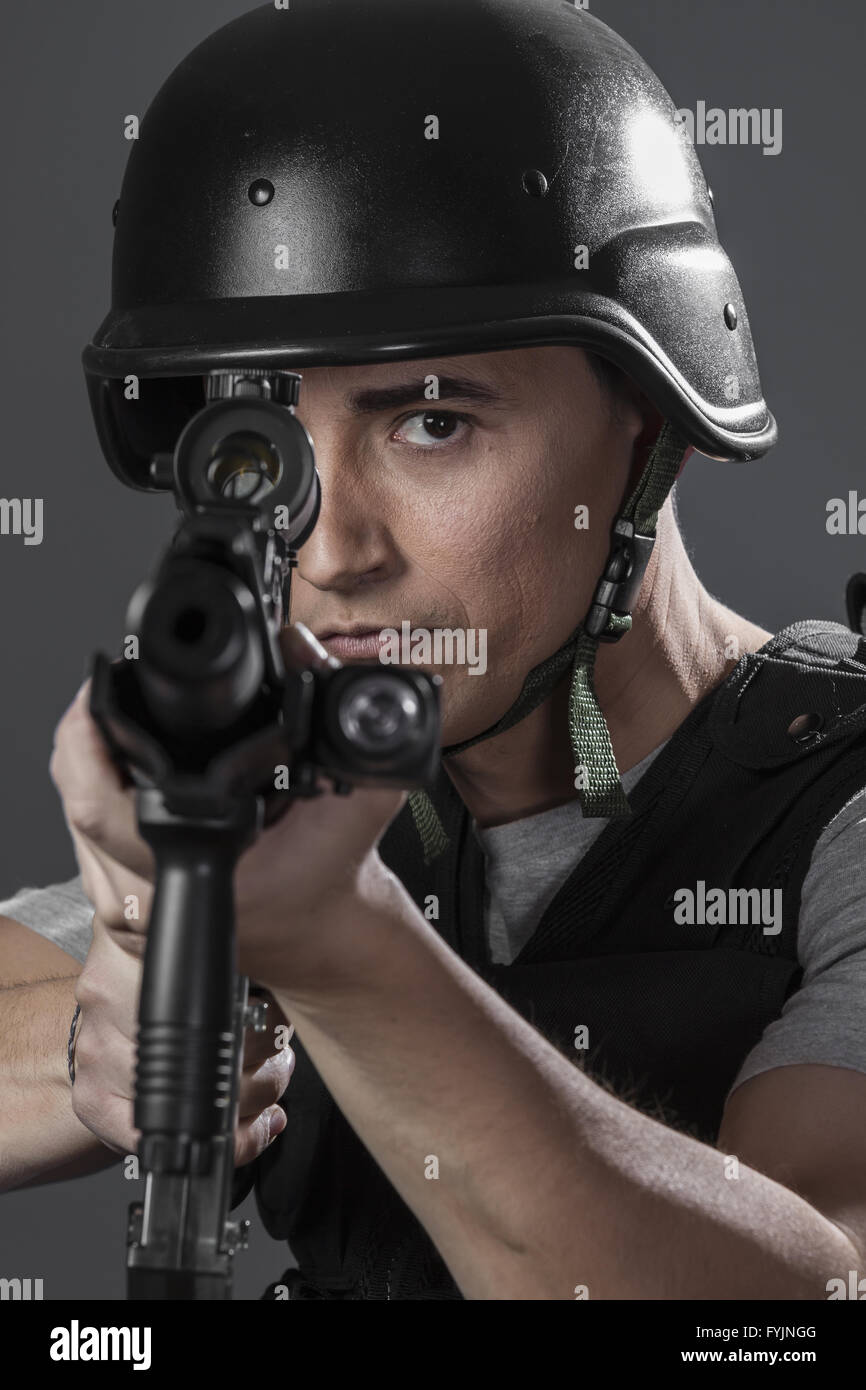 paintball sport player wearing protective helmet aiming pistol ,black ...
