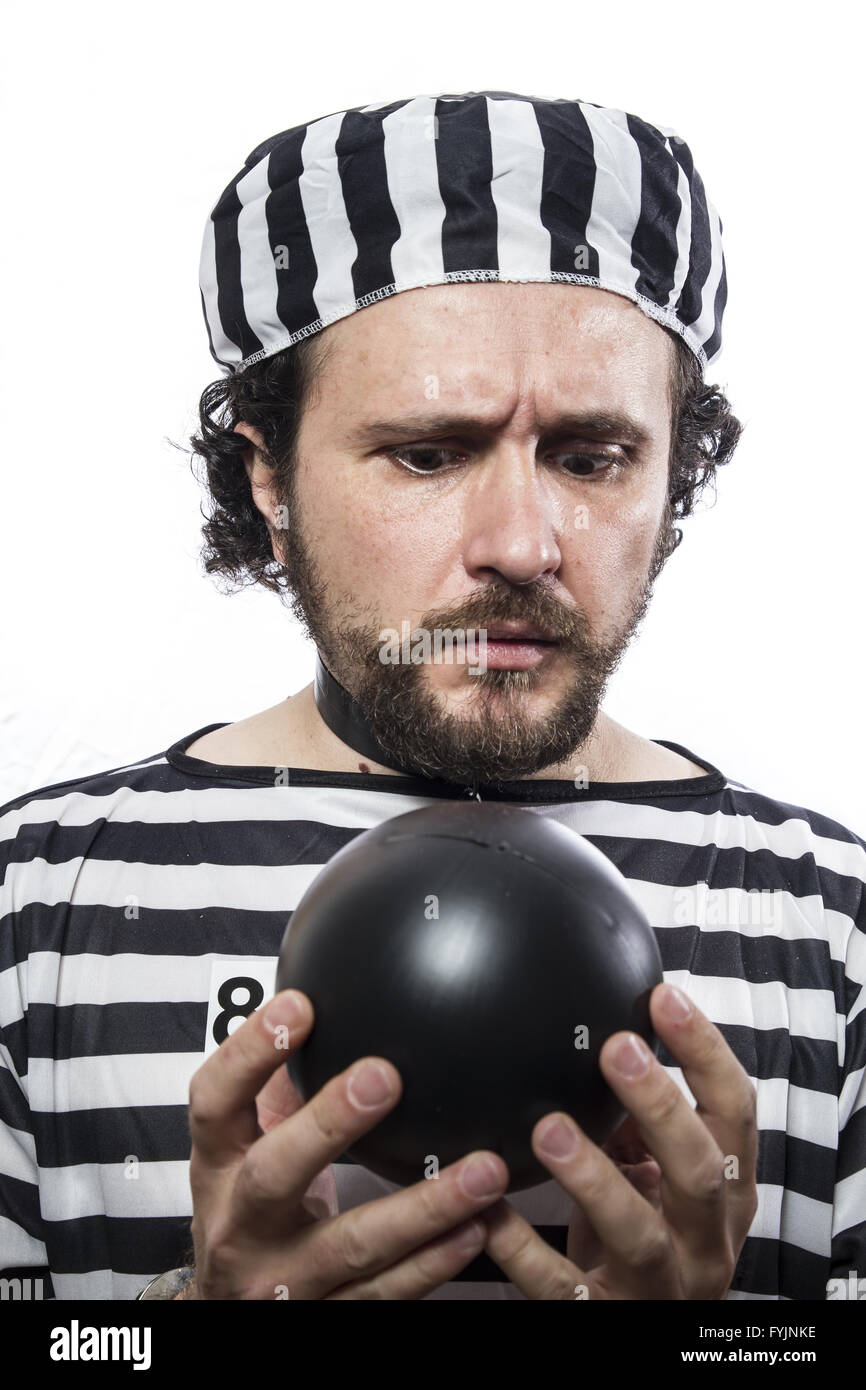 Funny man prisoner criminal with chain ball and handcuffs in studio ...