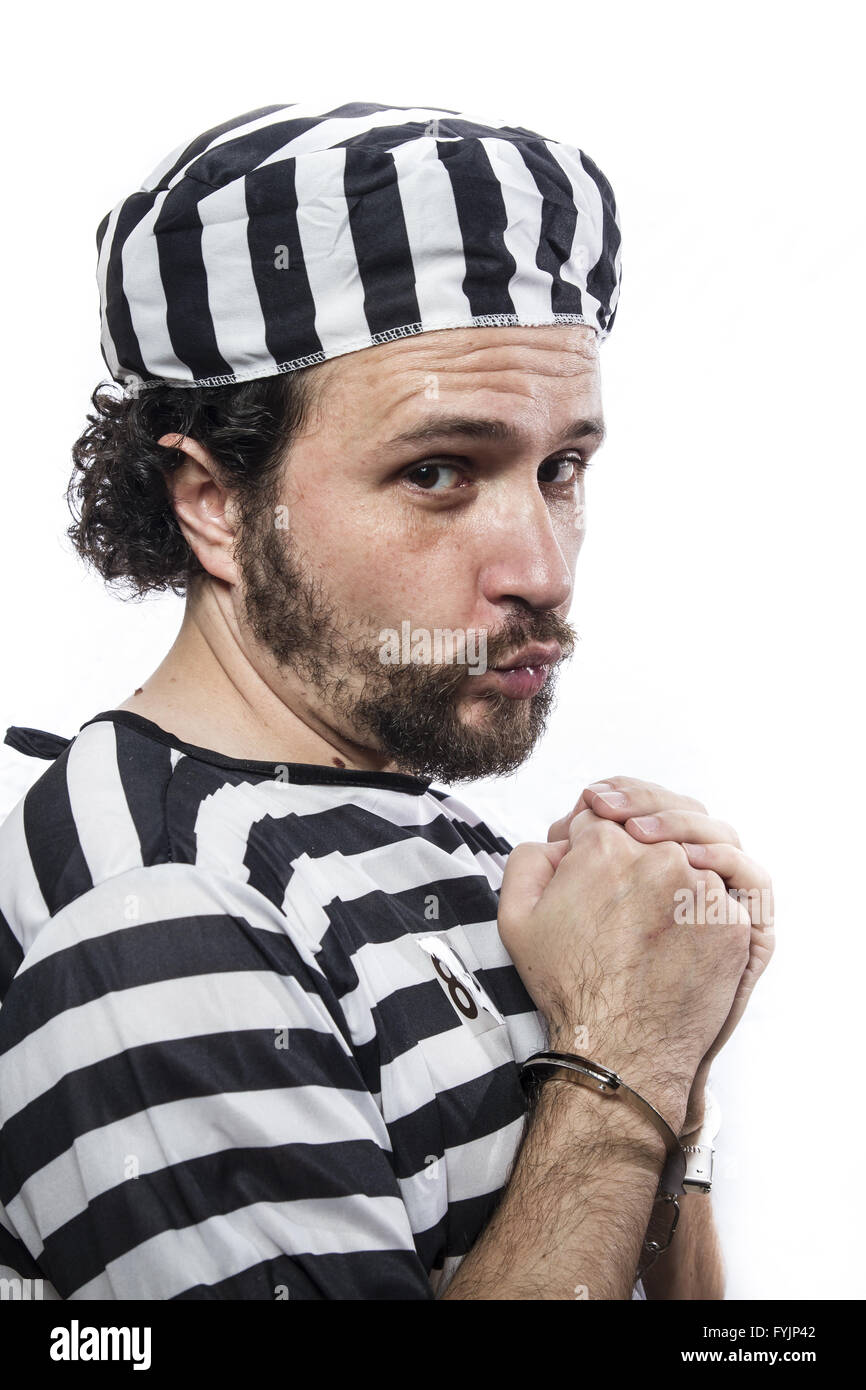 Locked, Desperate, portrait of a man prisoner in prison garb, over ...