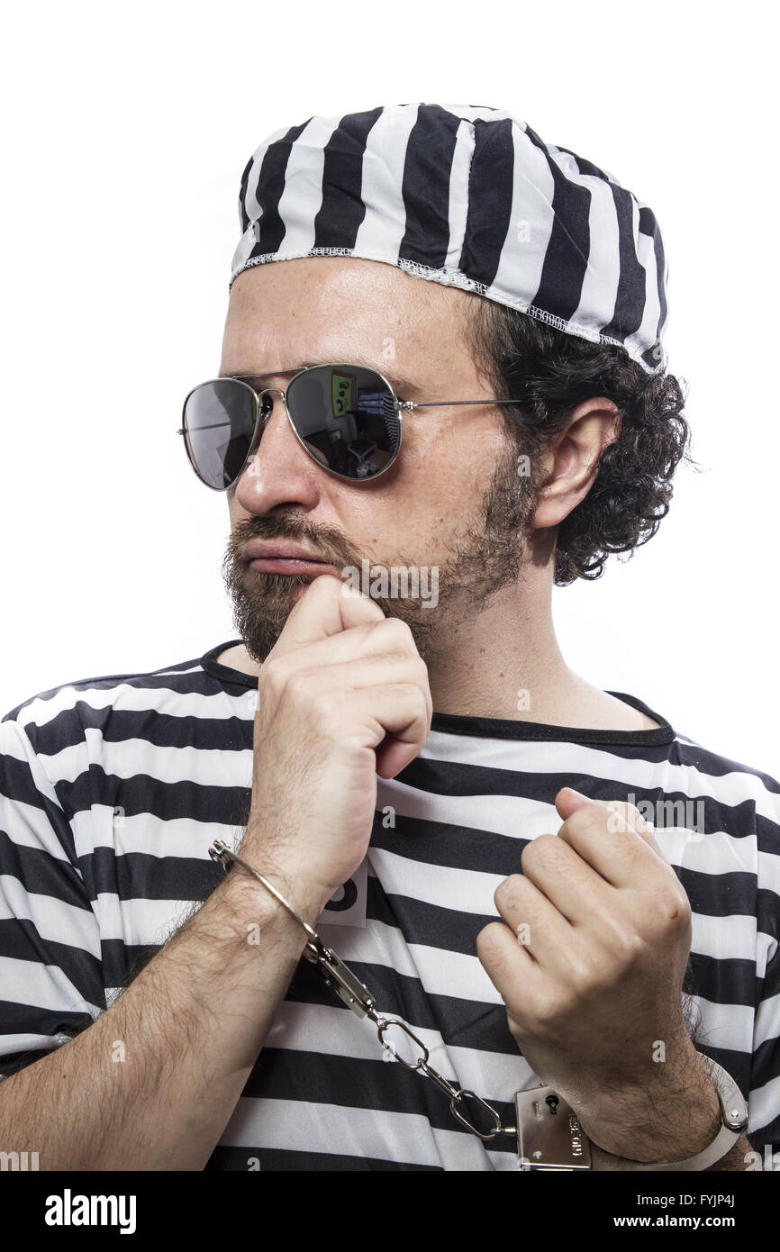 Desperate, portrait of a man prisoner in prison garb, over white ...