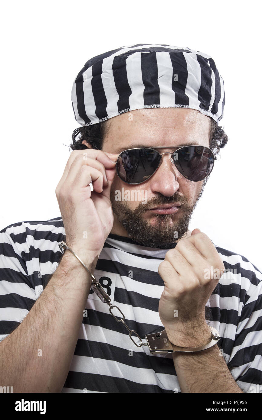 Desperate, portrait of a man prisoner in prison garb, over white ...