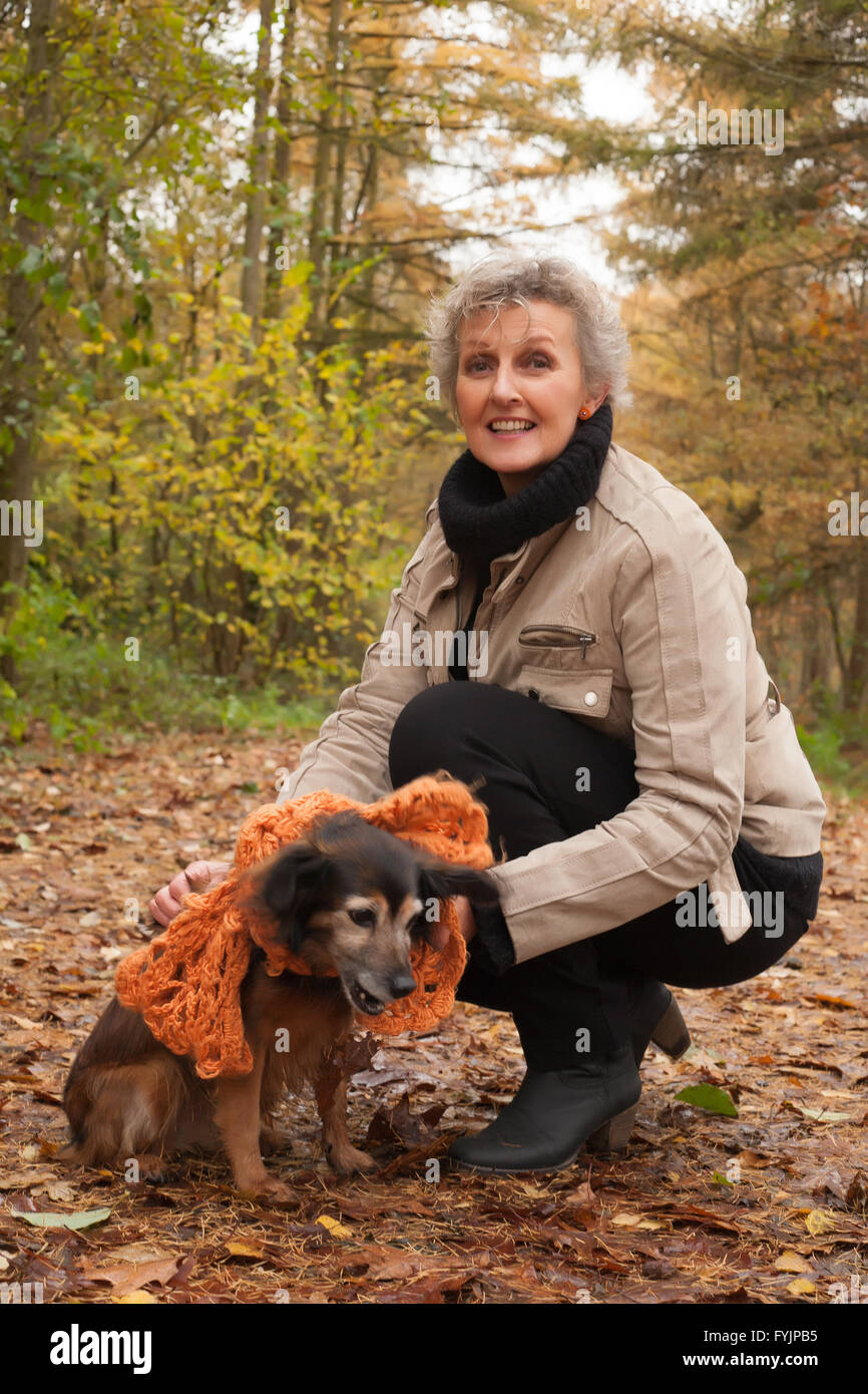 Middle ager is sitting with the dog Stock Photo - Alamy