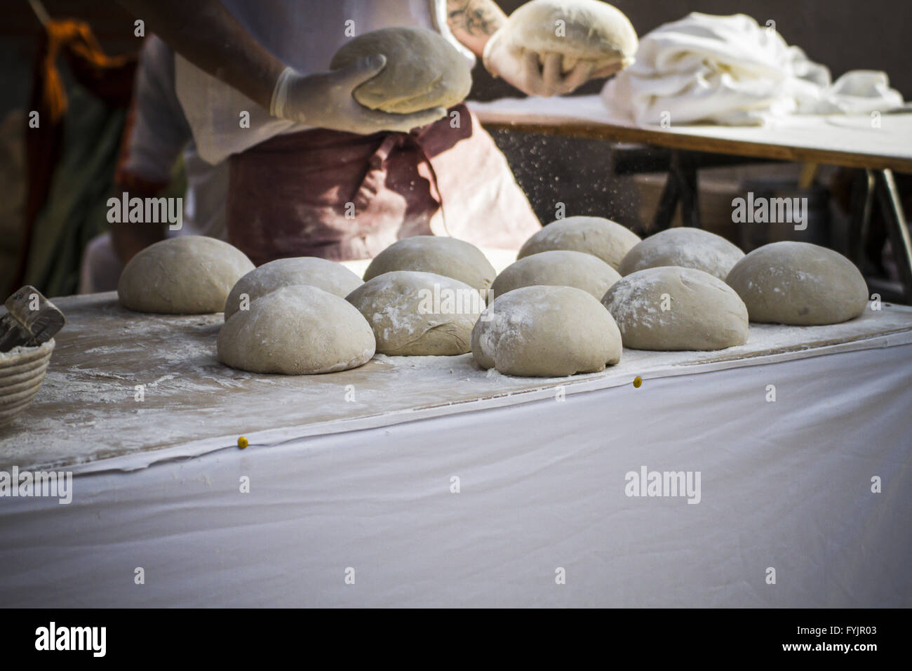 Baker making artisan bread in a medieval fair Stock Photo - Alamy