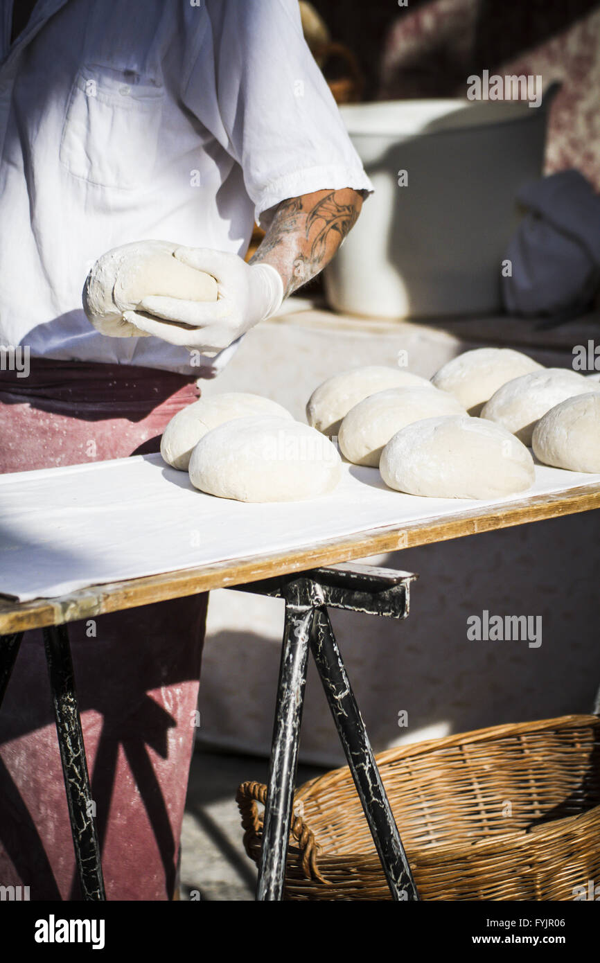 Baker making artisan bread in a medieval fair Stock Photo - Alamy