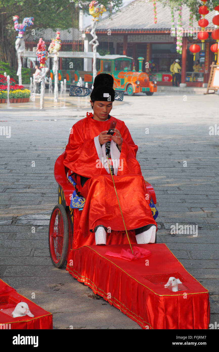 Chinese actor in a carnival costume sitting in a fake boat Stock Photo ...