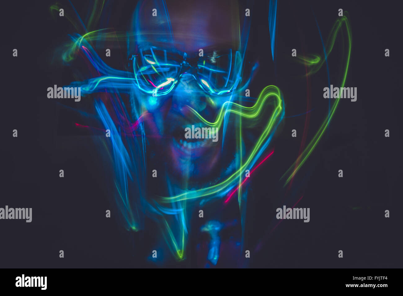 Motion, effect lightpainting man with sunglasses and colored lights ...