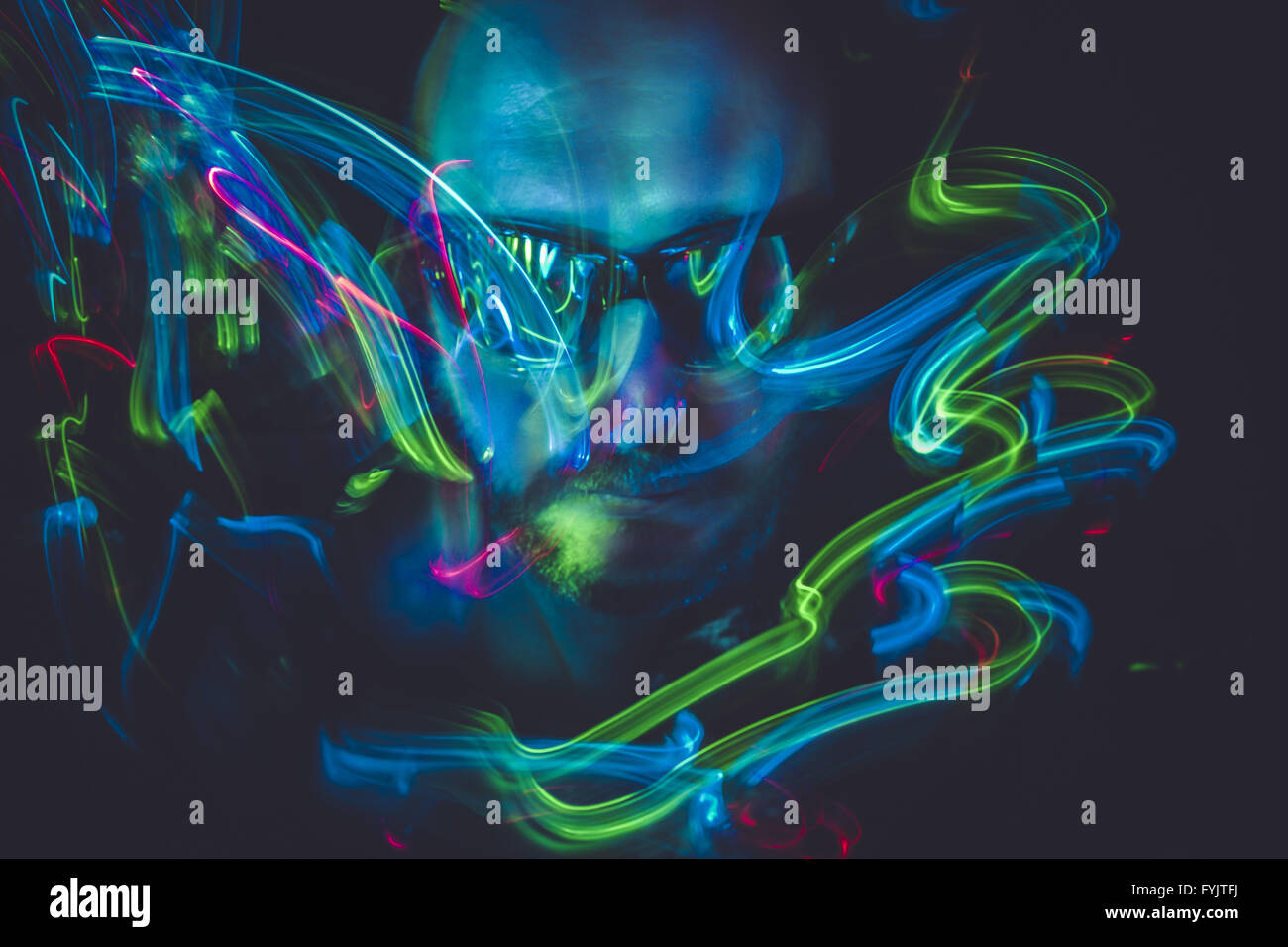 paranormal effect lightpainting man with sunglasses and colored lights ...
