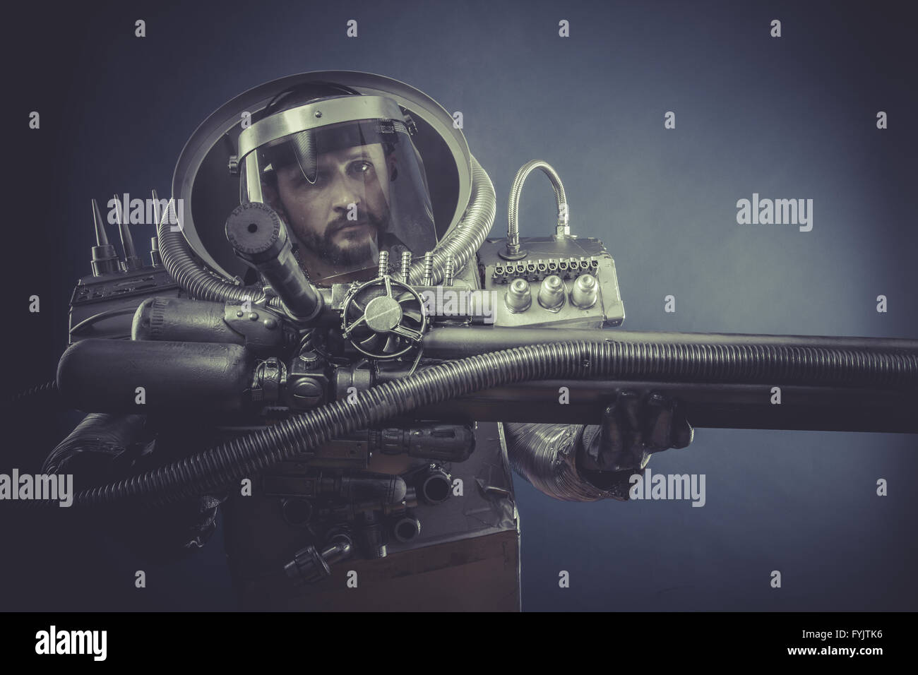 exploration, spaceman in silver armor and huge cannon Stock Photo - Alamy
