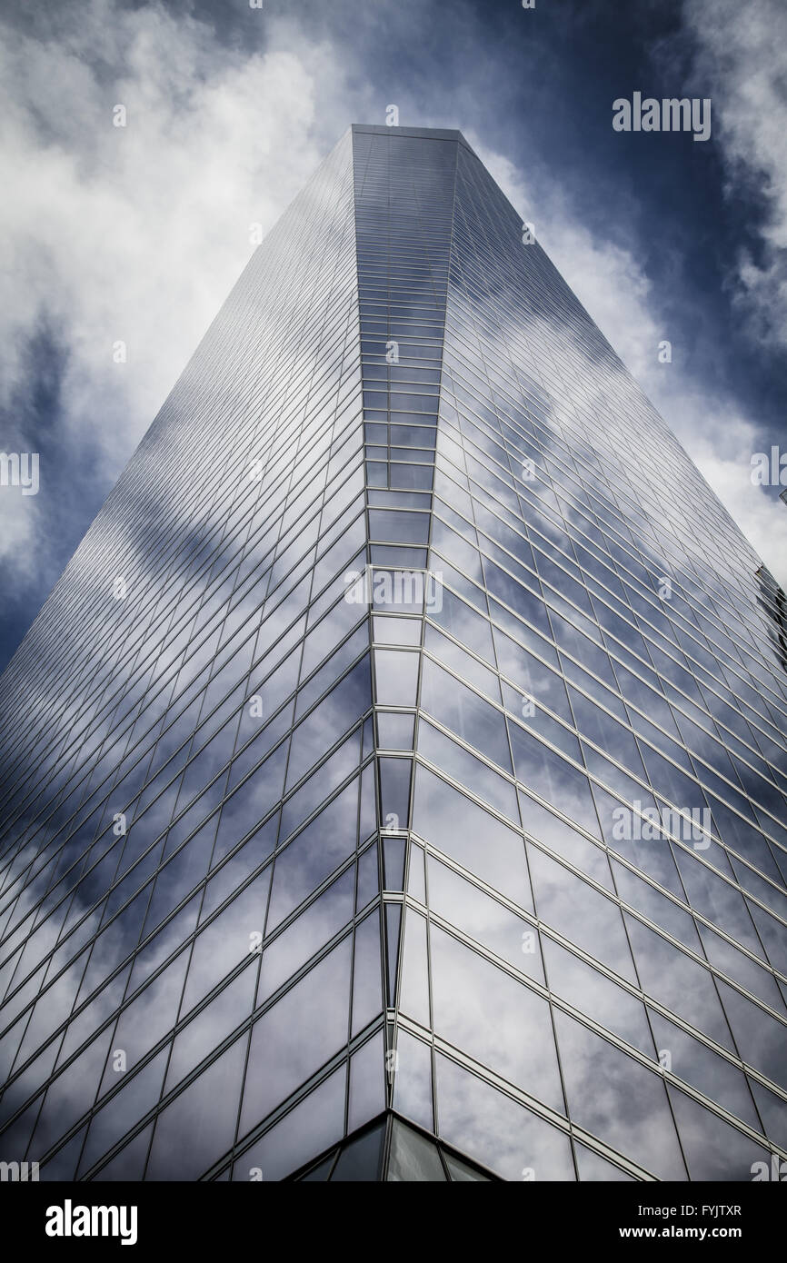 enterprise, skyscraper with glass facade and clouds reflected in ...