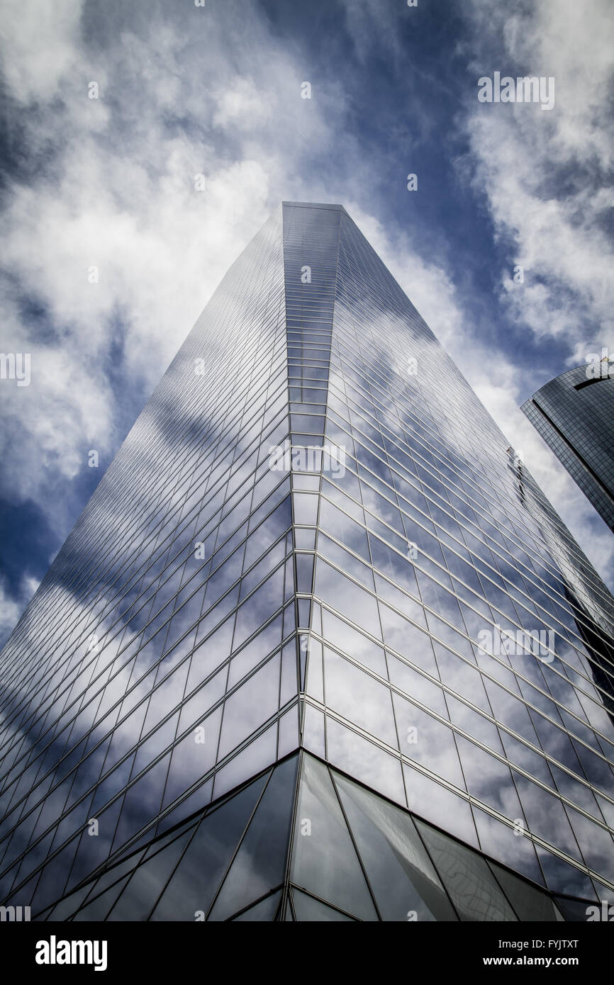 skyscraper with glass facade and clouds reflected in windows Stock ...