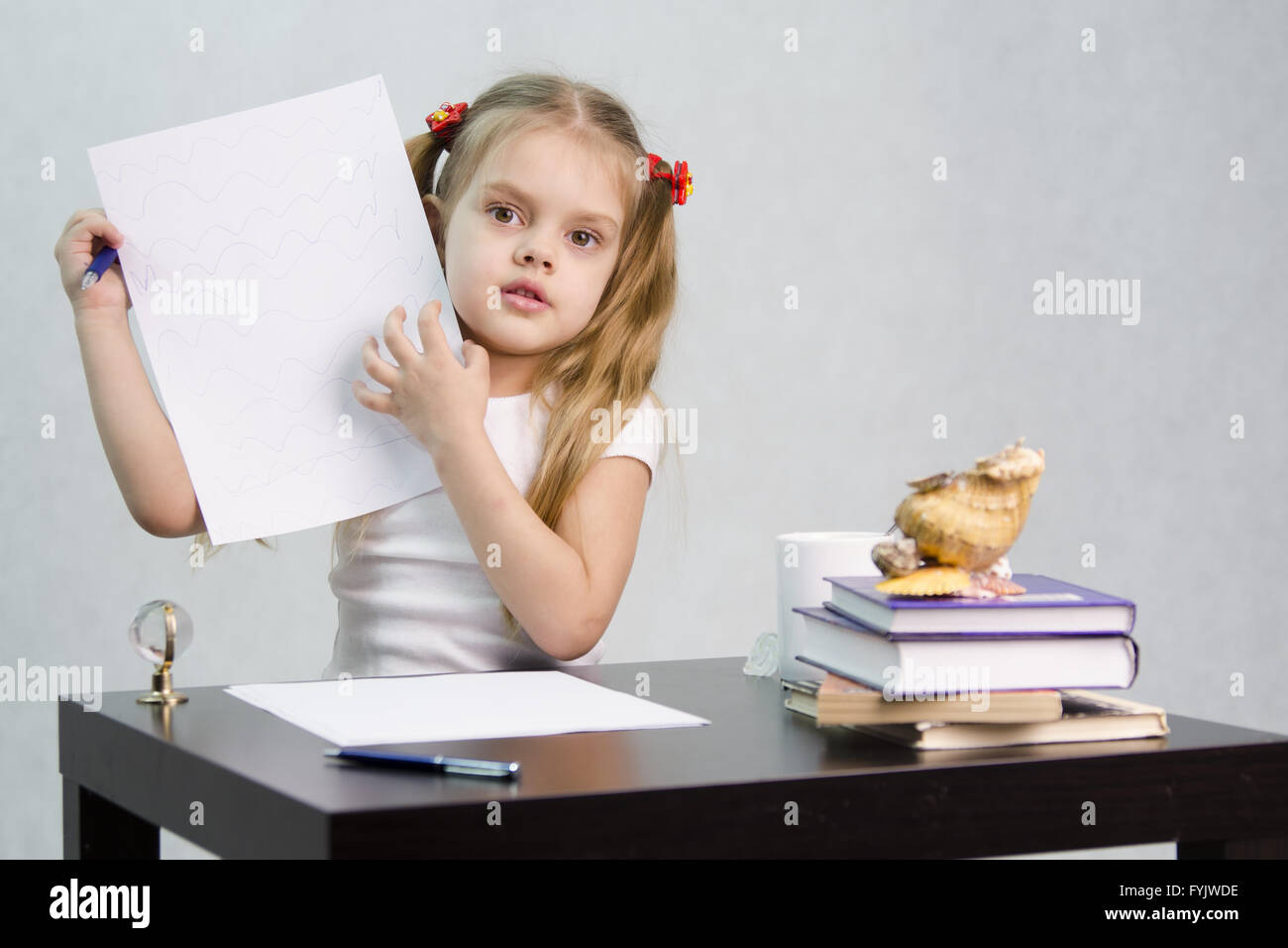 Girl shows sheet of paper with scribbled notes Stock Photo - Alamy