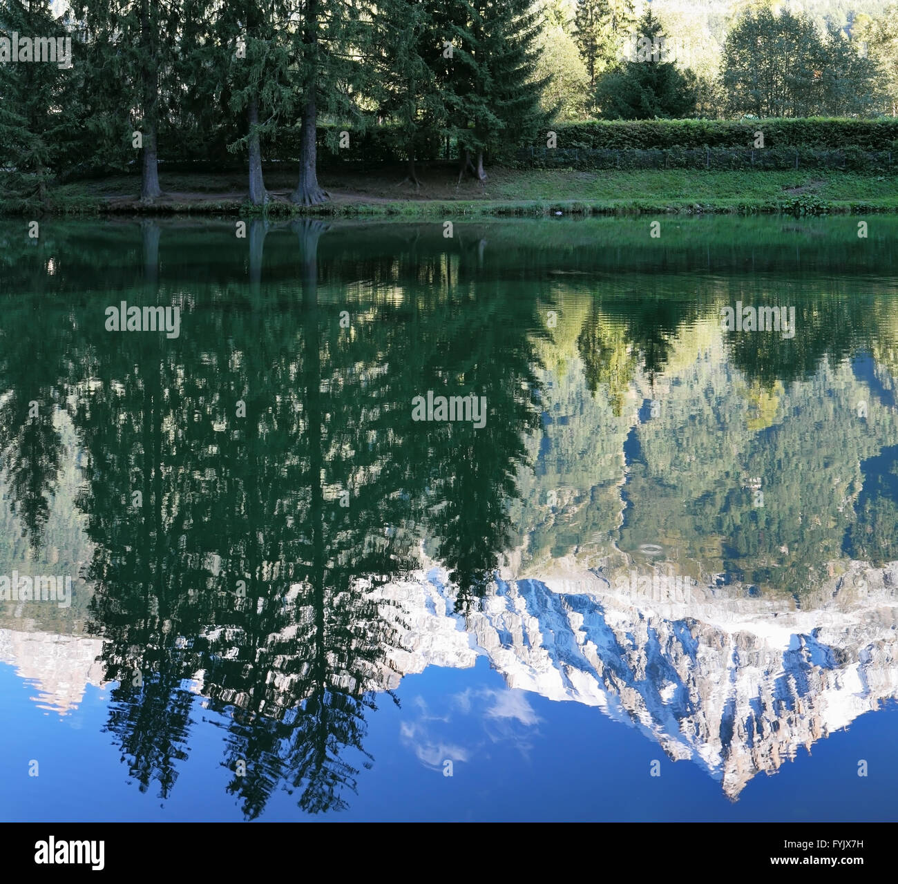 The mountains reflected in the smooth water of the lake Stock Photo - Alamy