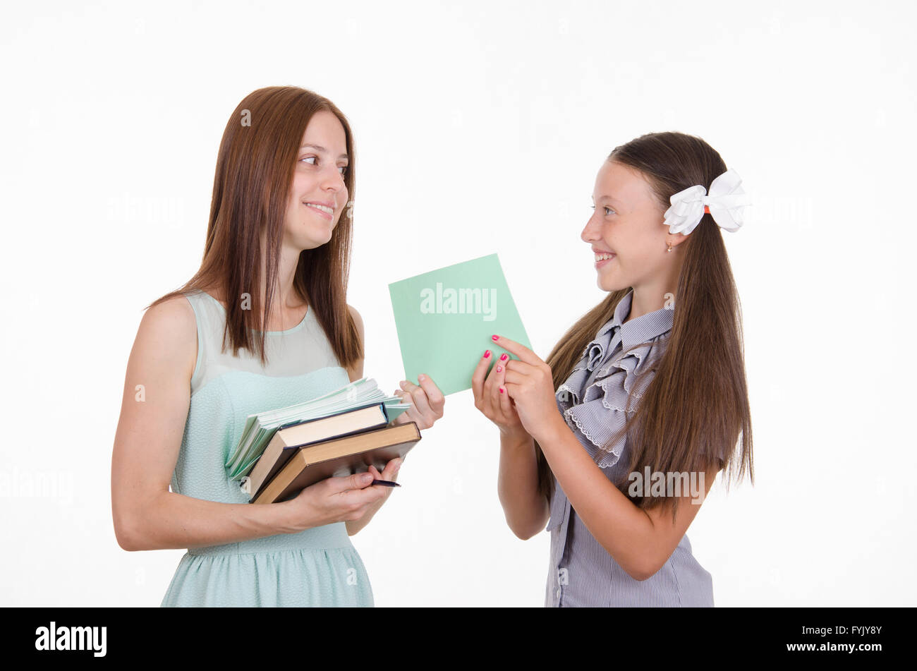 The teacher gives the student a proven notebook Stock Photo - Alamy