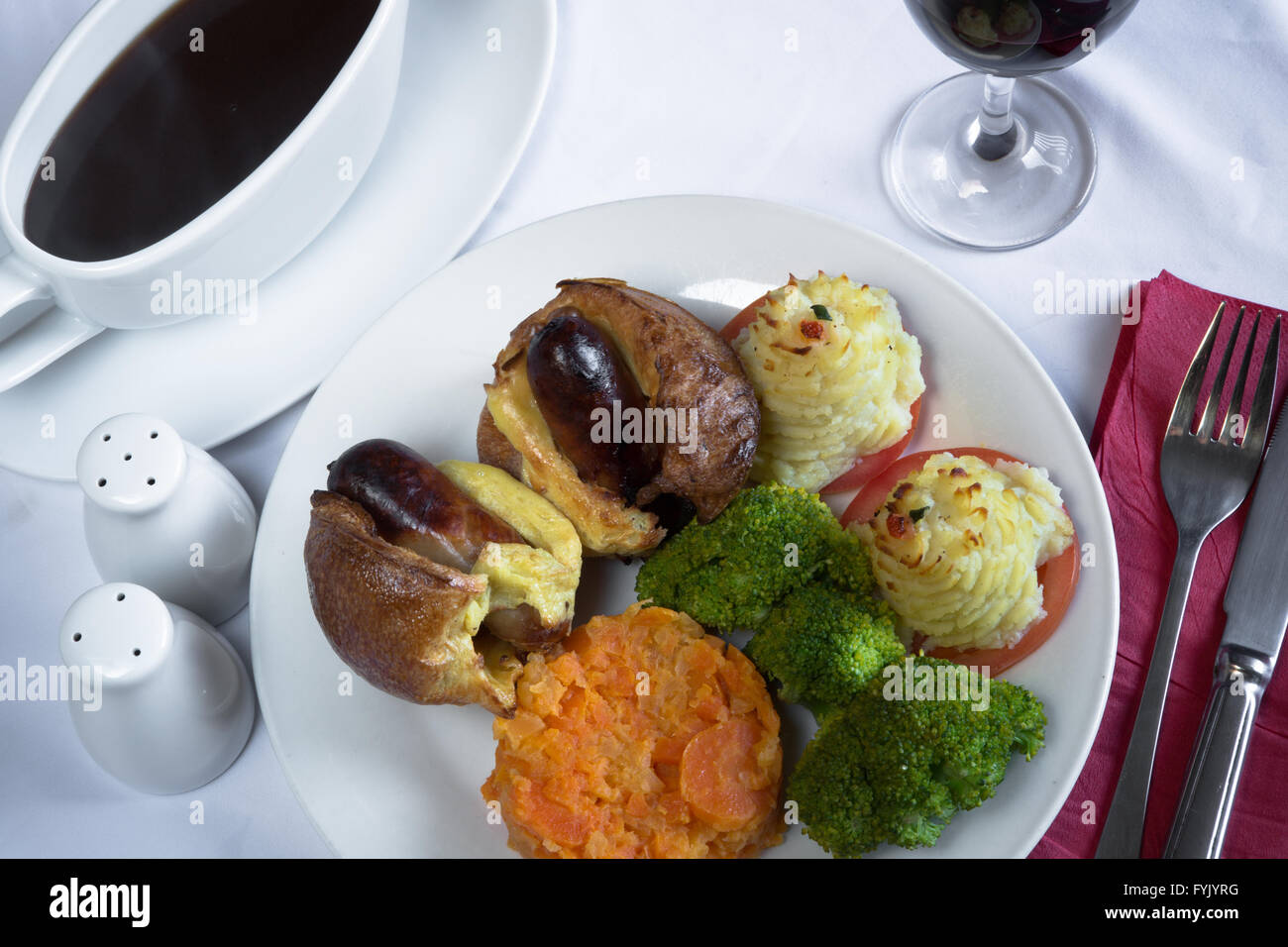 A serving of English style Toad in the Hole with Duchess Potato ...