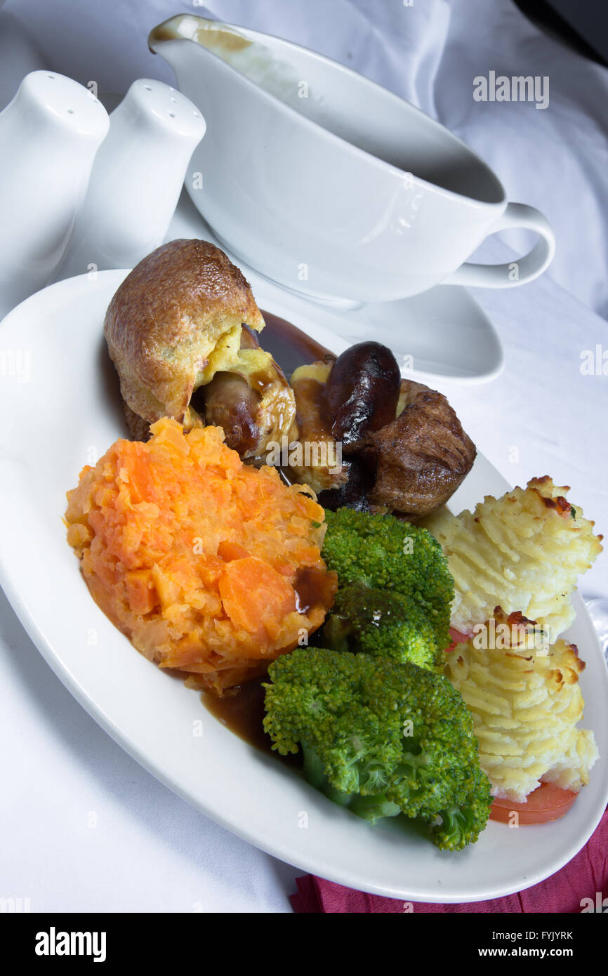 A serving of English style Toad in the Hole with Duchess Potato ...