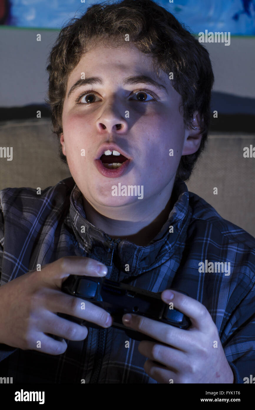 Happy. boy with joystick playing computer game at home Stock Photo - Alamy