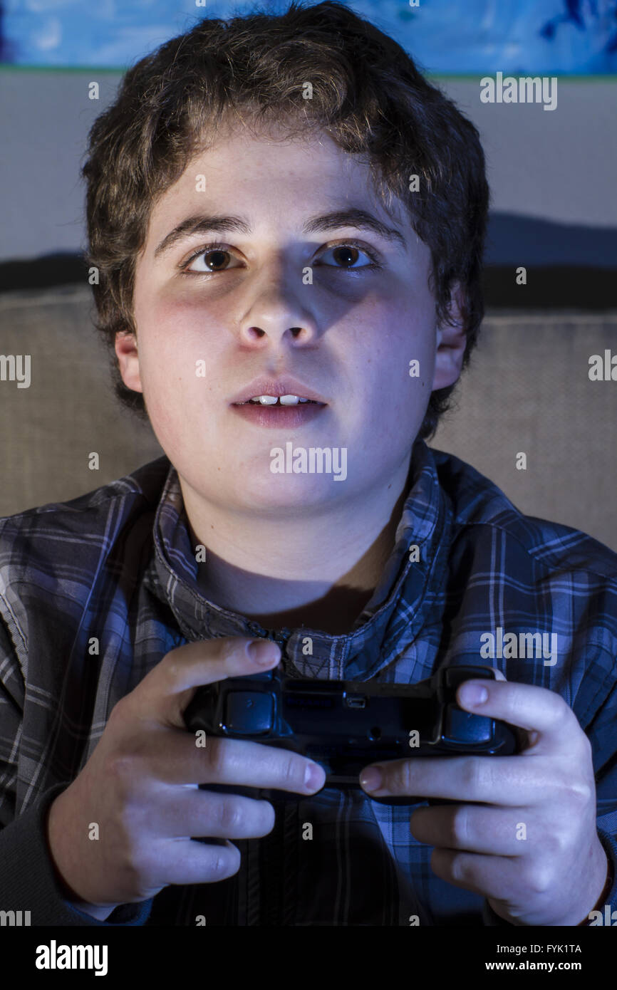 Fun boy with joystick playing computer game at home Stock Photo - Alamy