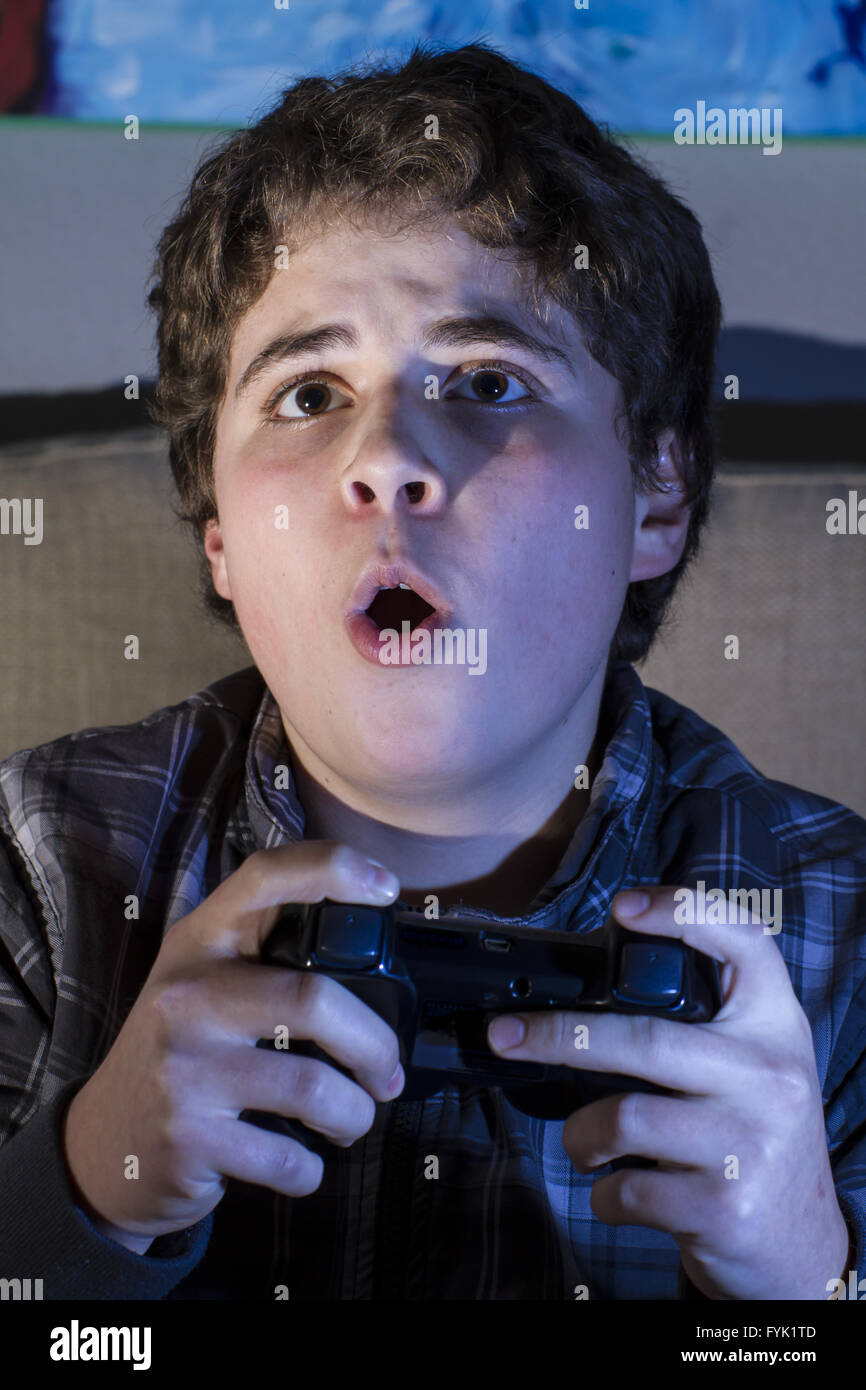 Technology. boy with joystick playing computer game at home Stock Photo ...