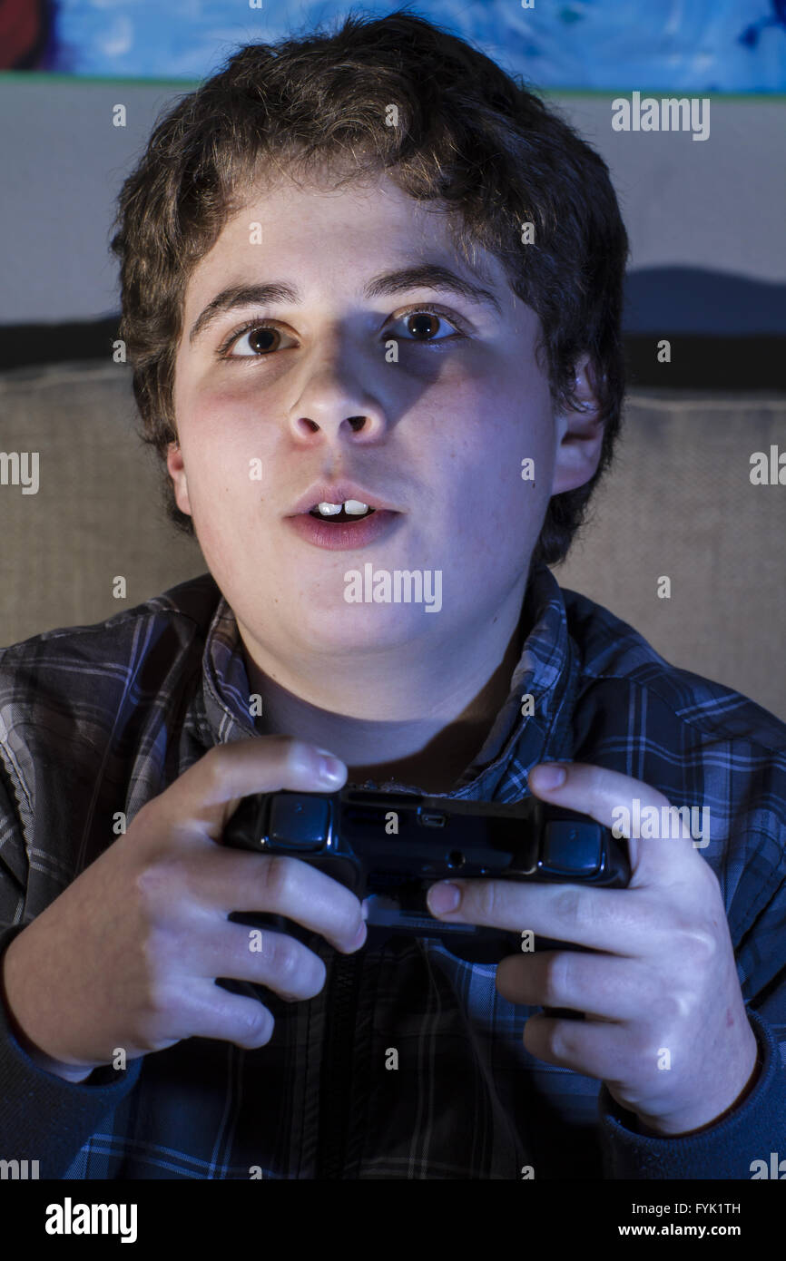 Technology. boy with joystick playing computer game at home Stock Photo ...
