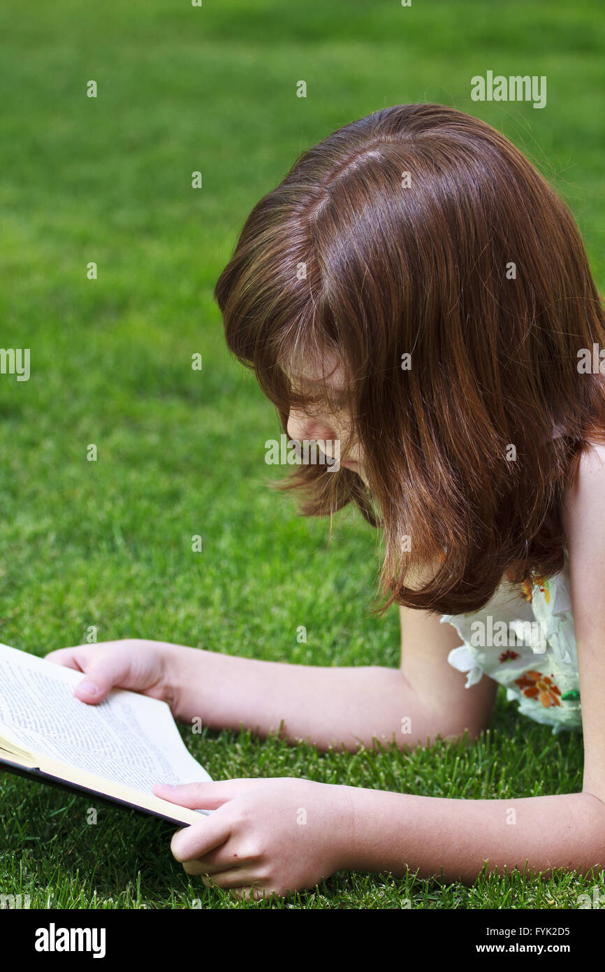 Education.Young beautiful girl reading a book outdoor Stock Photo - Alamy