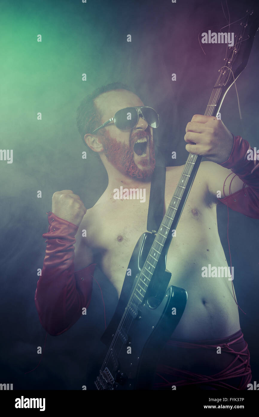 Metal, rocker man with electric guitar in a rock concert Stock Photo ...