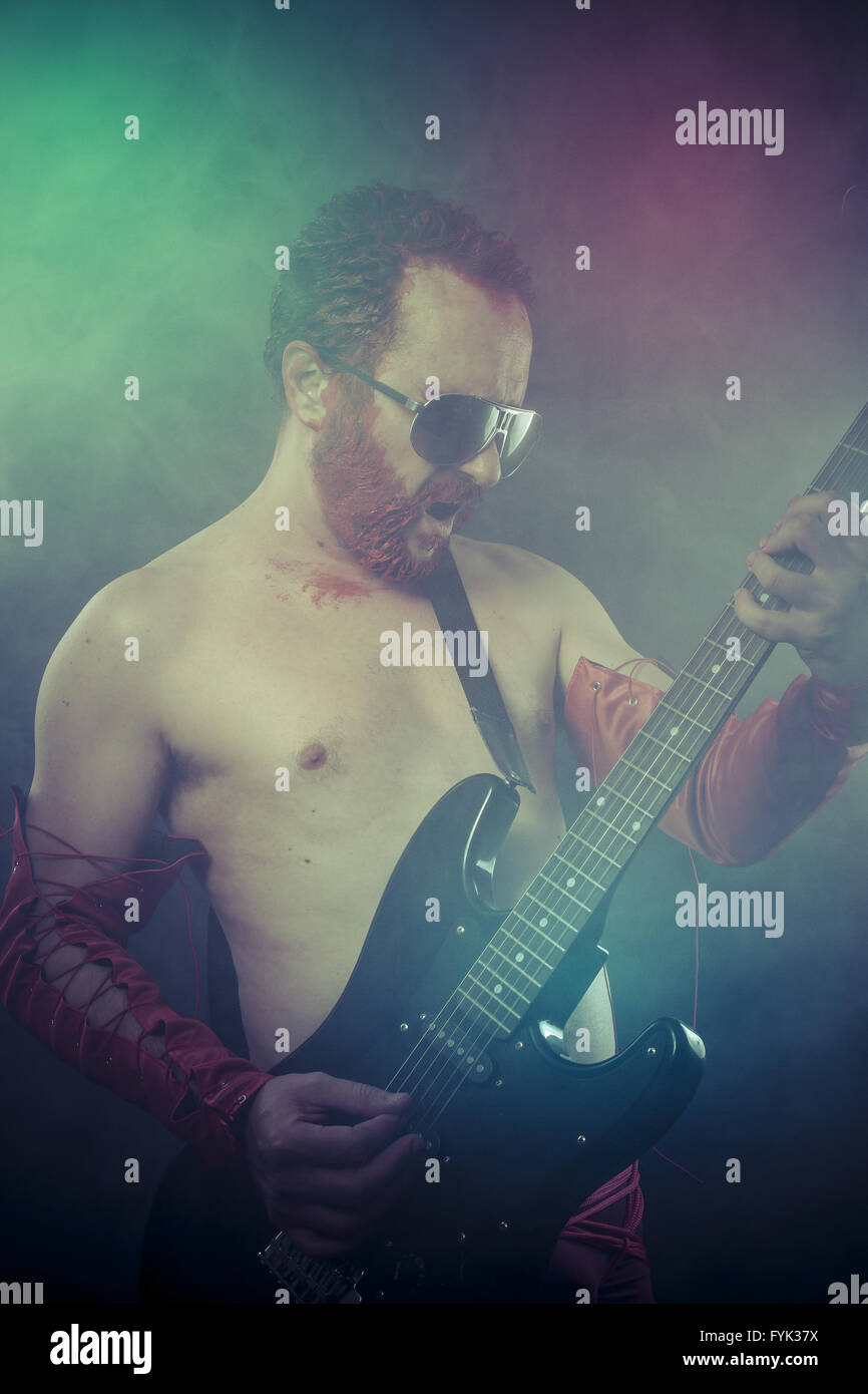 Heavy, rocker man with electric guitar in a rock concert Stock Photo ...