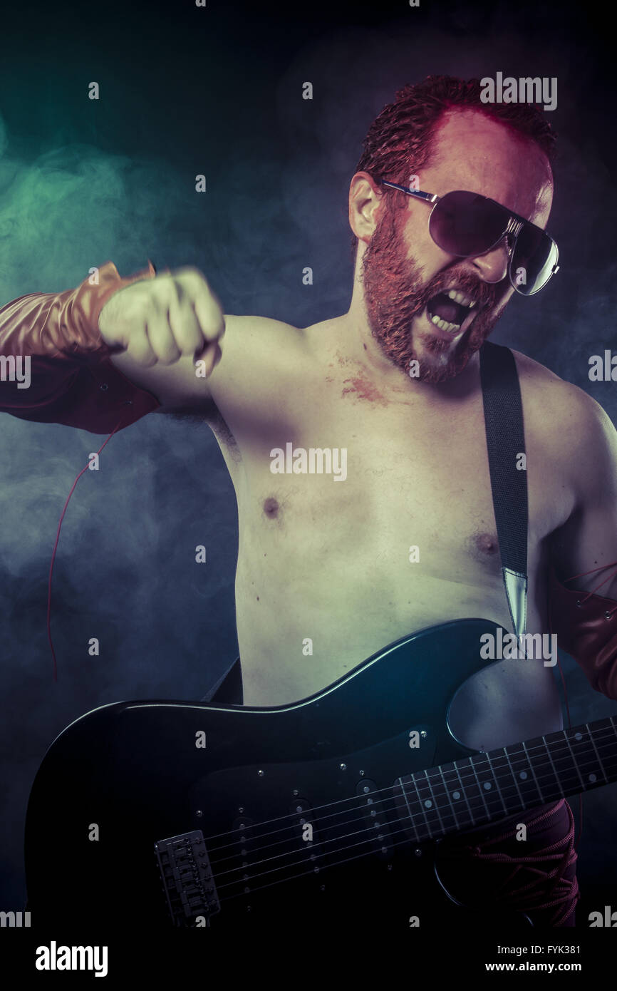 rocker man with electric guitar in a rock concert Stock Photo - Alamy