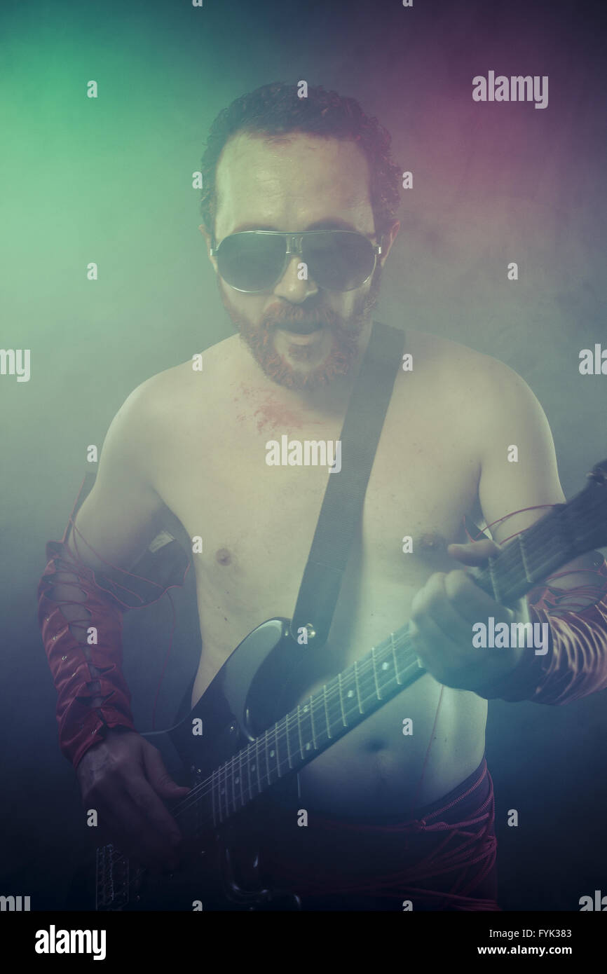 rocker man with electric guitar in a rock concert Stock Photo - Alamy