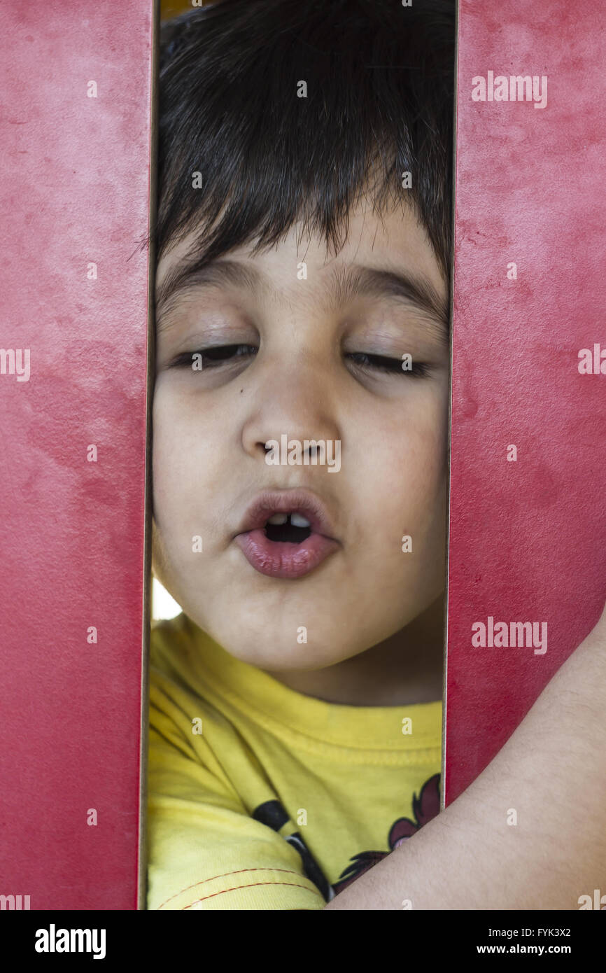 Cute child in a park putting expressive faces Stock Photo - Alamy