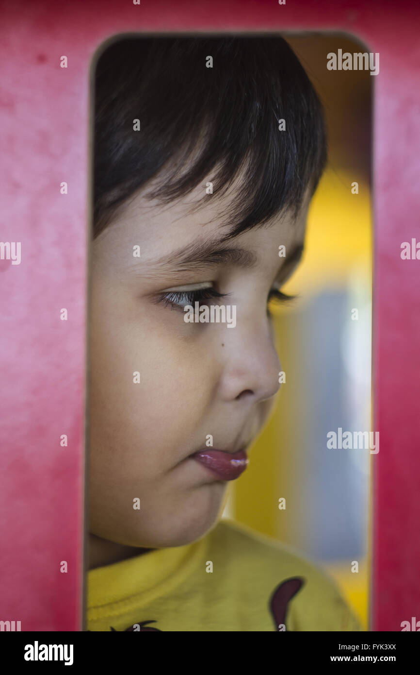 Sad child in a park putting expressive faces Stock Photo - Alamy