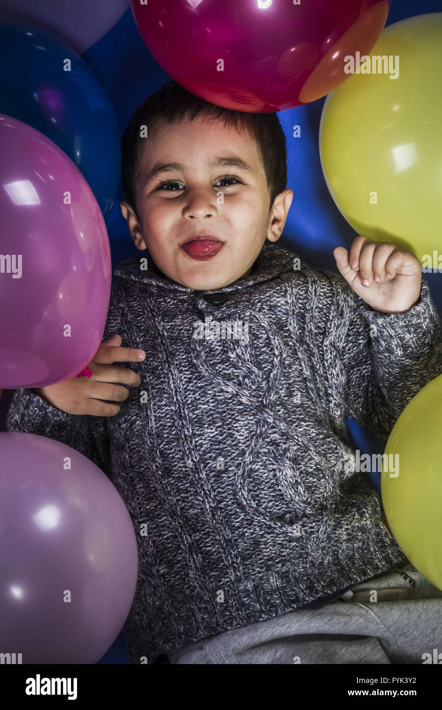 Play boy playing with balloons of many colors Stock Photo - Alamy