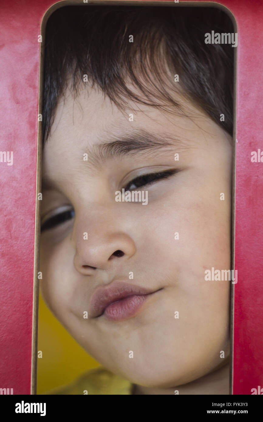 Handsome child in a park putting expressive faces Stock Photo - Alamy