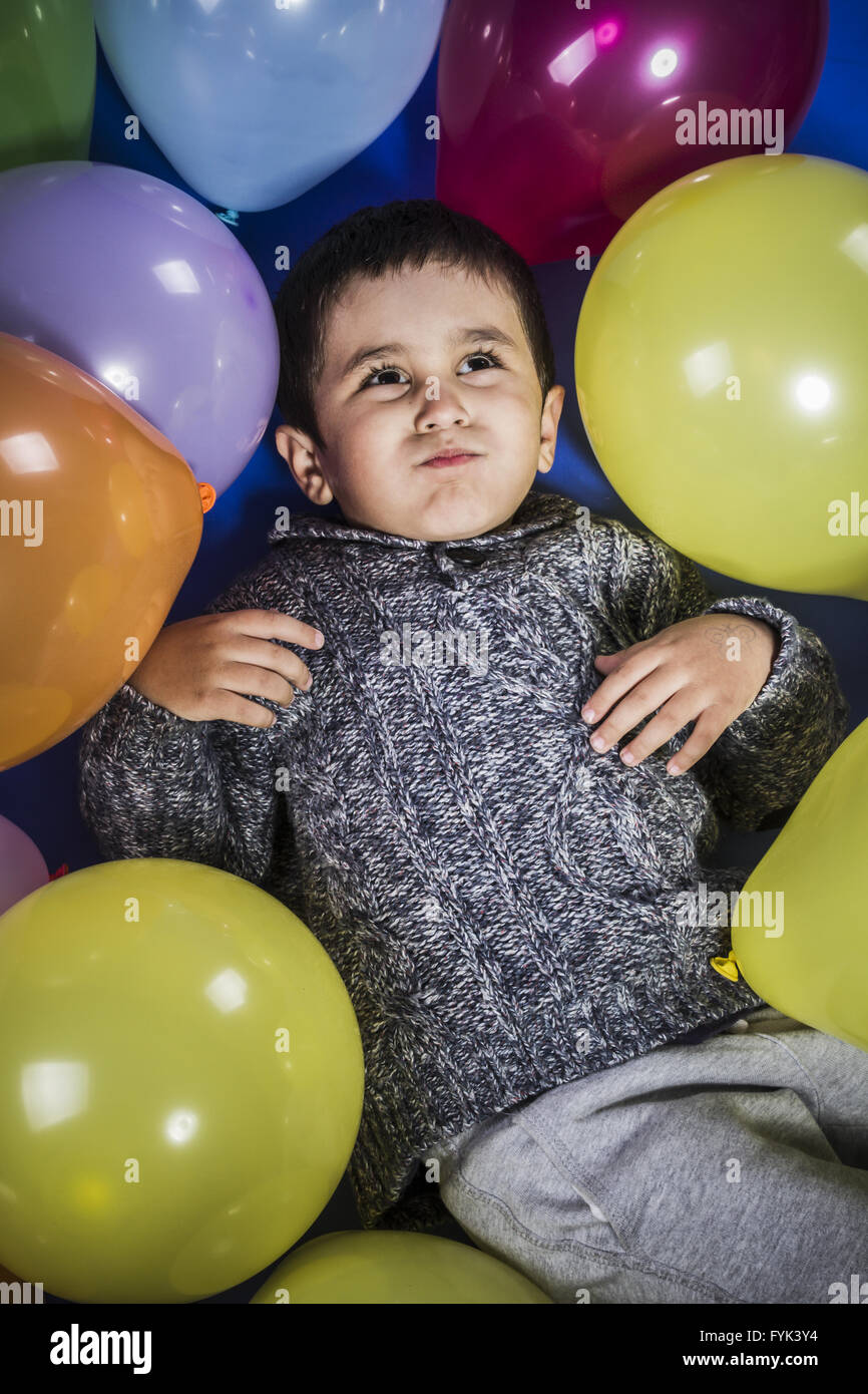 boy playing with balloons of many colors Stock Photo - Alamy