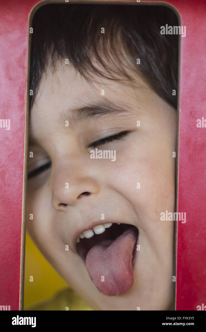 Smile, child in a park putting expressive faces Stock Photo - Alamy