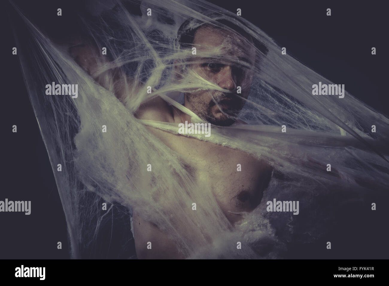 Depression, Man trapped in a spider web Stock Photo - Alamy